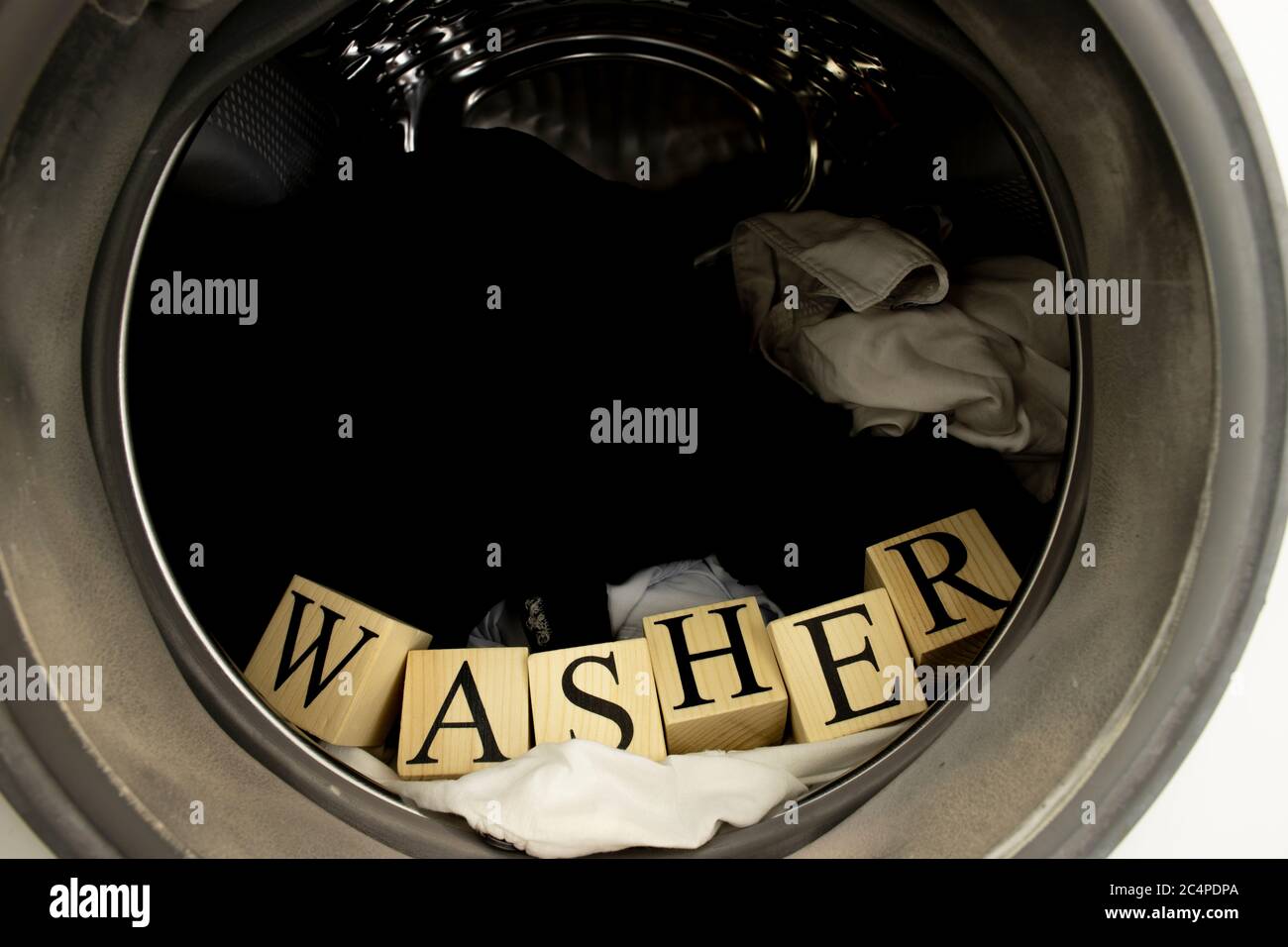 Inside the washing machine. Inside, there is laundry and text from ...