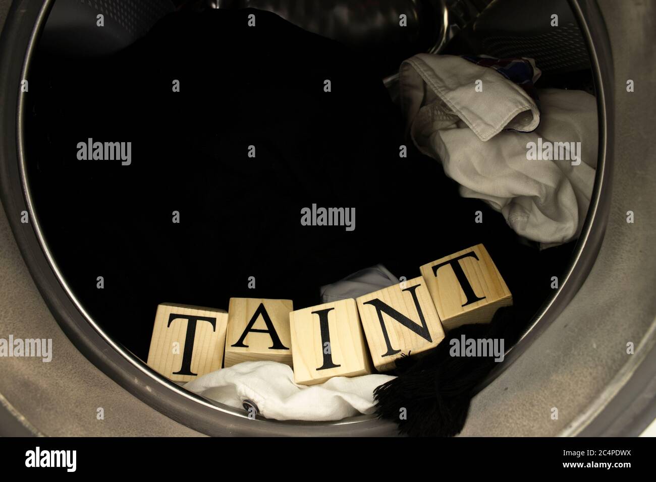 Inside the washing machine. Inside, there is laundry and text from ...