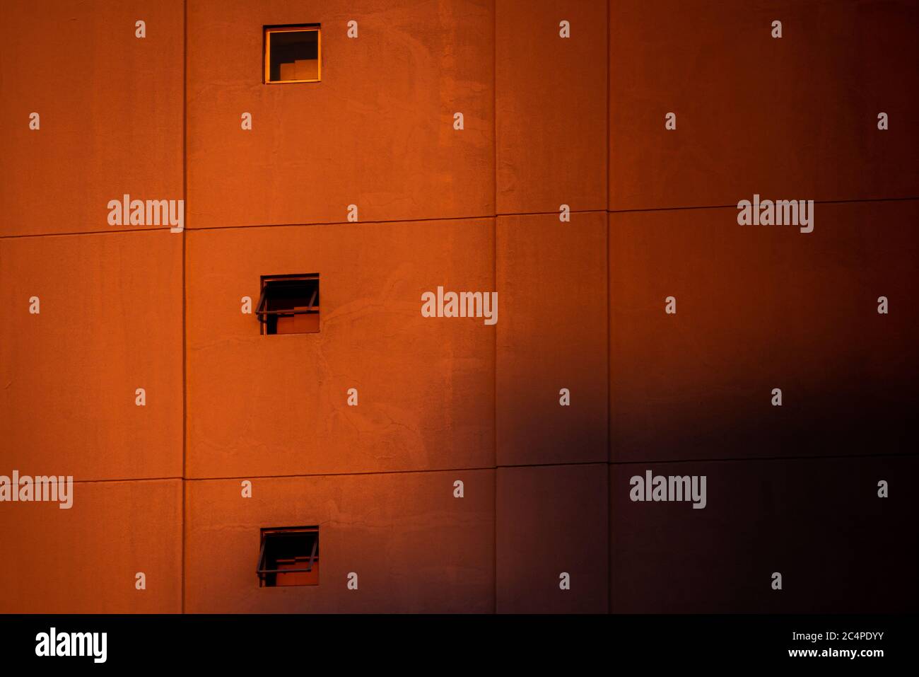 Shapes of windows and shadows illuminated by the red light of the ...