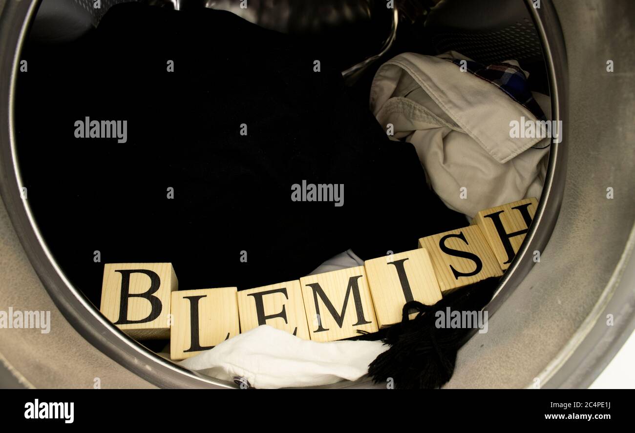 Inside the washing machine. Inside, there is laundry and text from ...