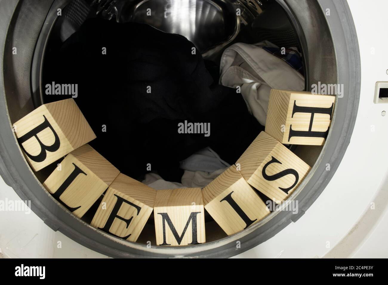 Inside the washing machine. Inside, there is laundry and text from ...