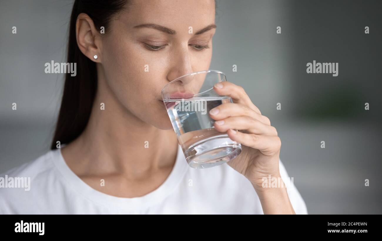 Thirsty female drinking pure water from glass Stock Photo - Alamy