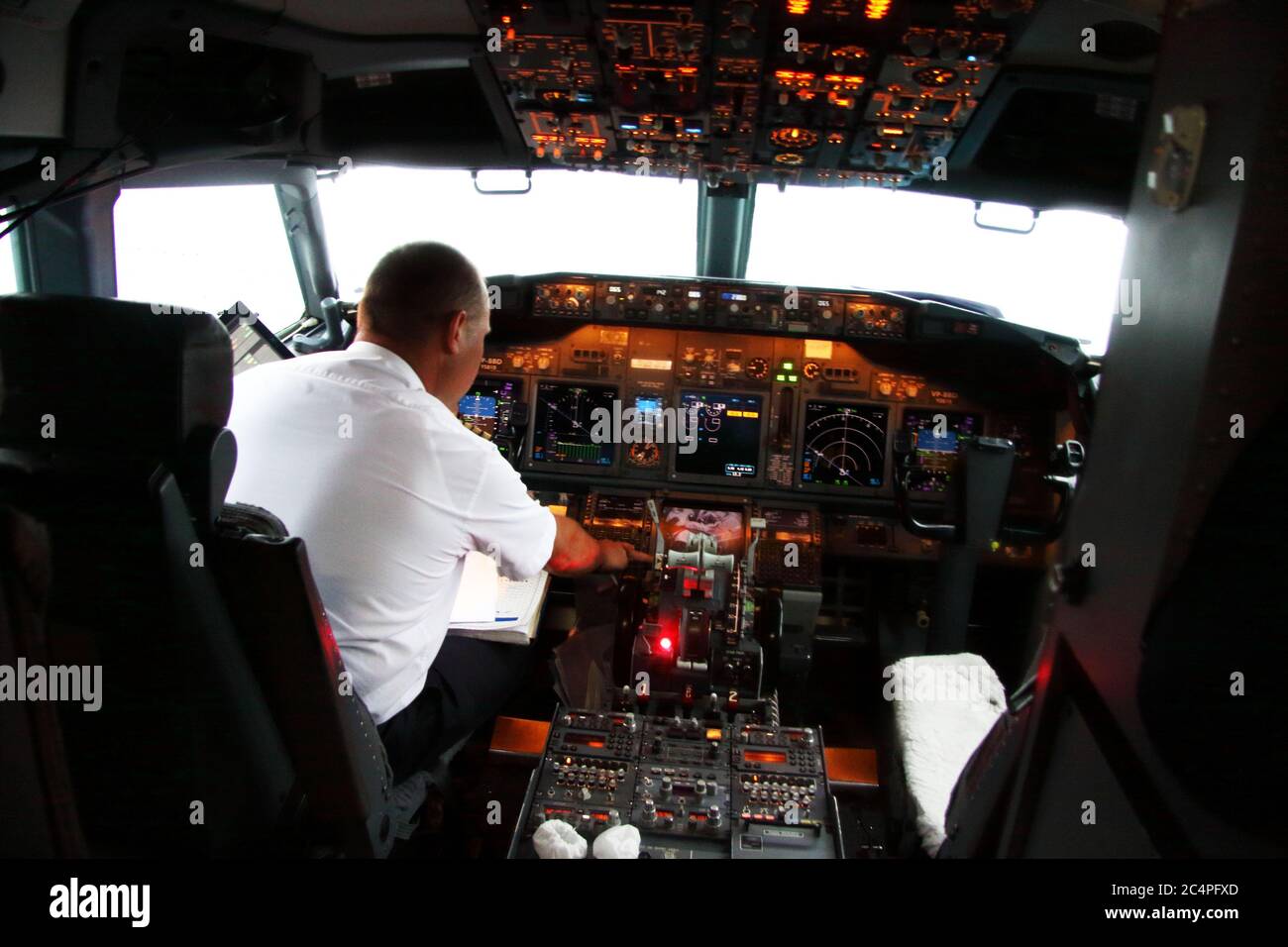 pilot in the cabin checking display before flight Stock Photo - Alamy