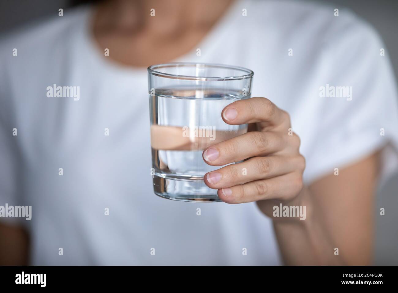 Young woman hold glass drinking pure mineral water Stock Photo - Alamy