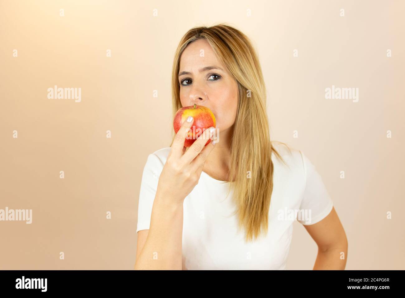 Blonde girl eating apple hi-res stock photography and images - Alamy
