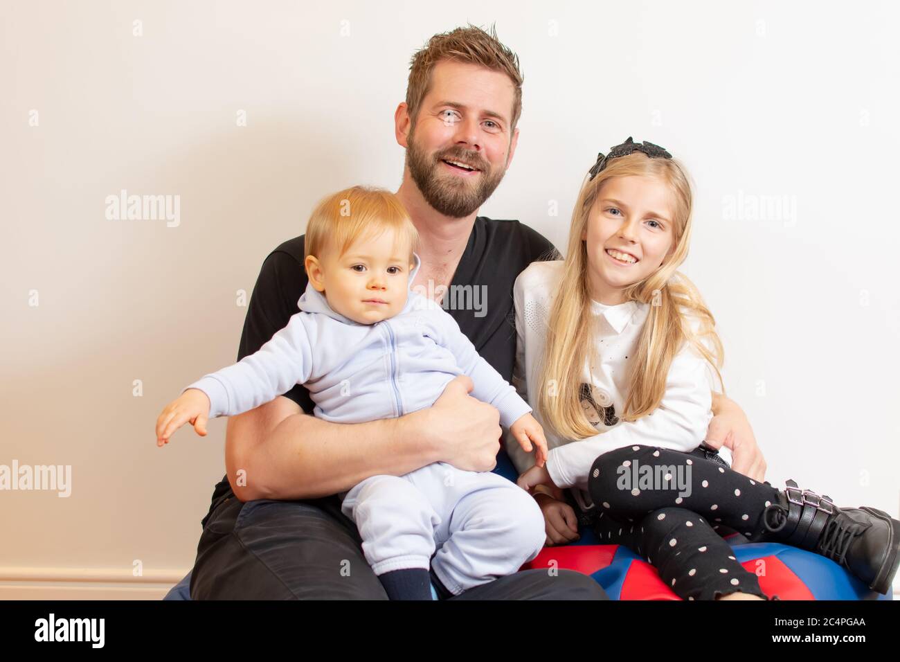 Father with his children smiling Stock Photo - Alamy