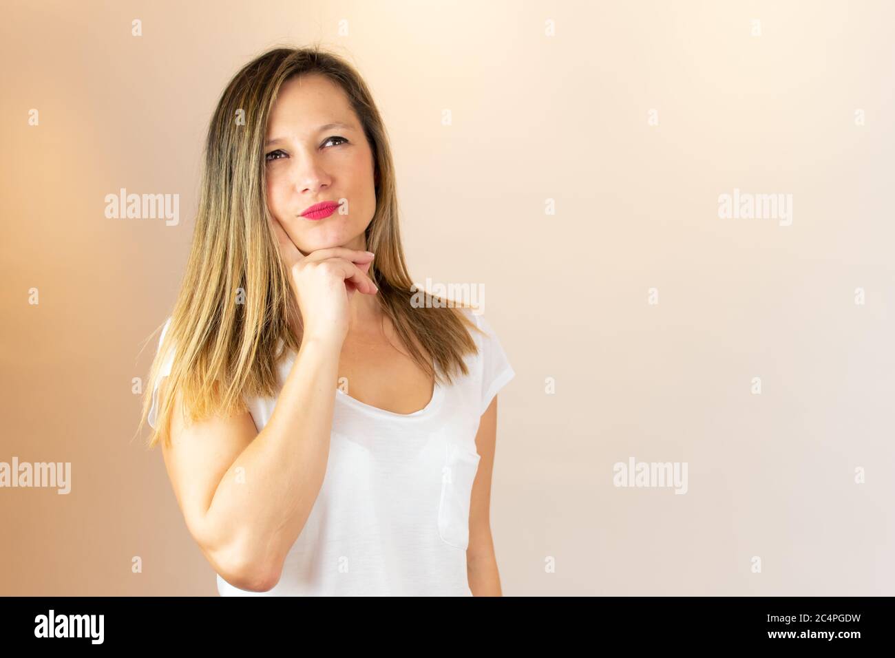 Young woman thoughtful looking upwards Stock Photo - Alamy