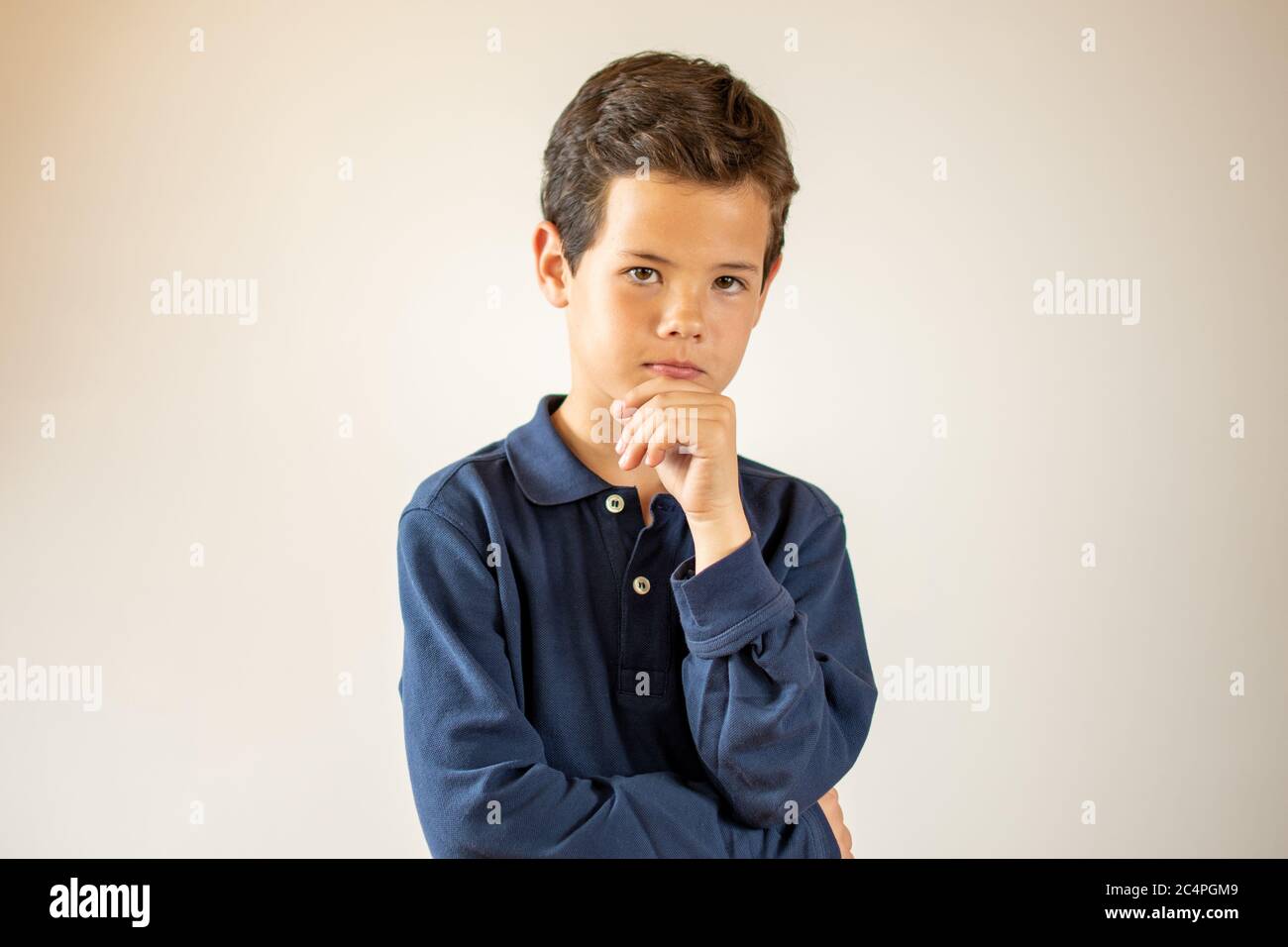 Young boy making the thoughtful gesture Stock Photo - Alamy