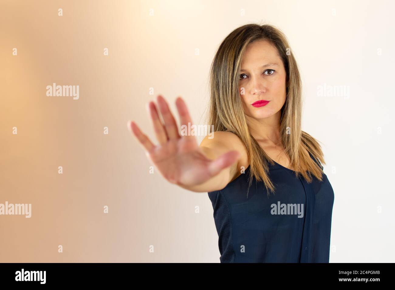 Young woman with straight arm making the stop gesture Stock Photo - Alamy