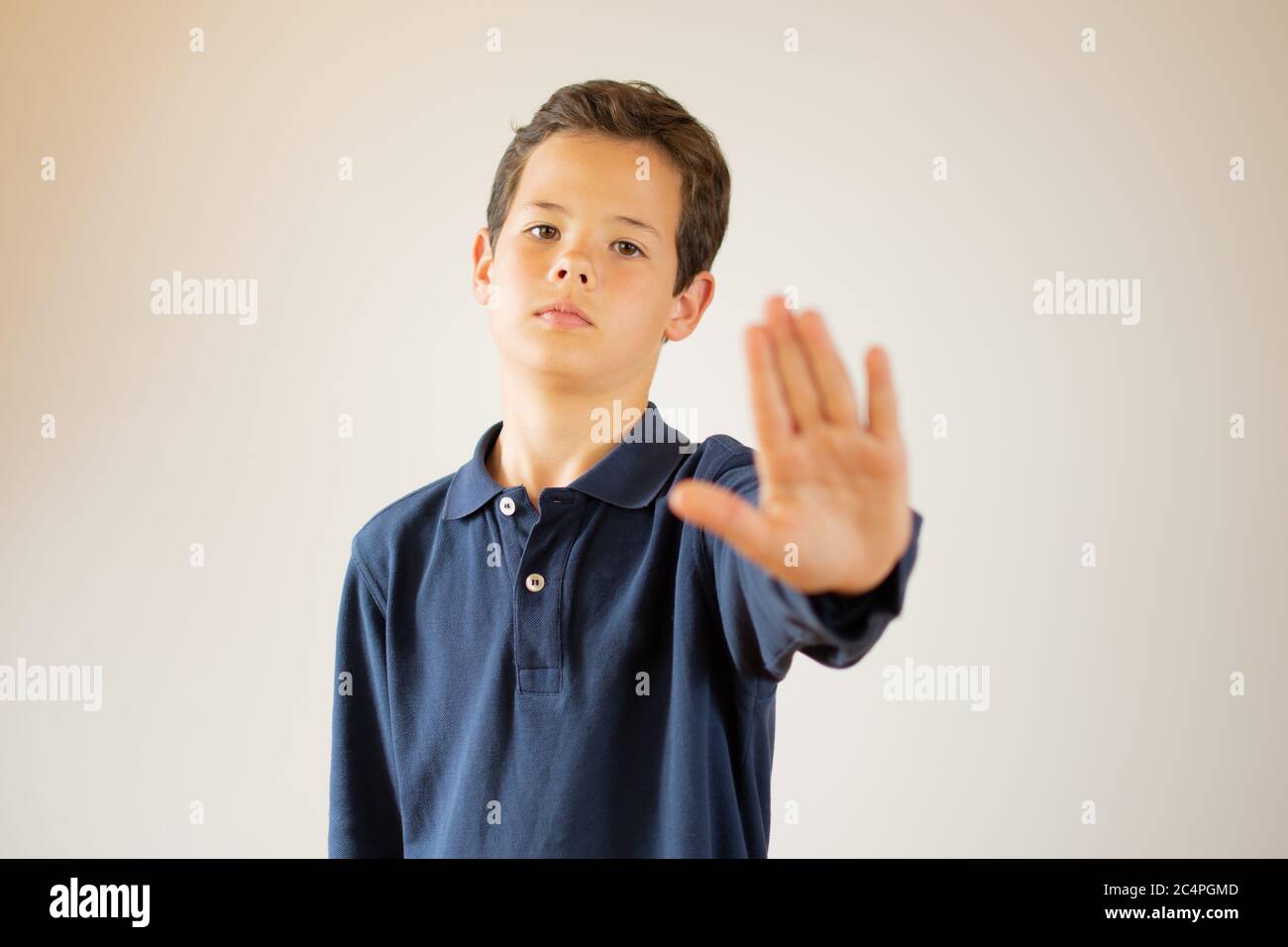 Young boy making the stop hand gesture Stock Photo - Alamy