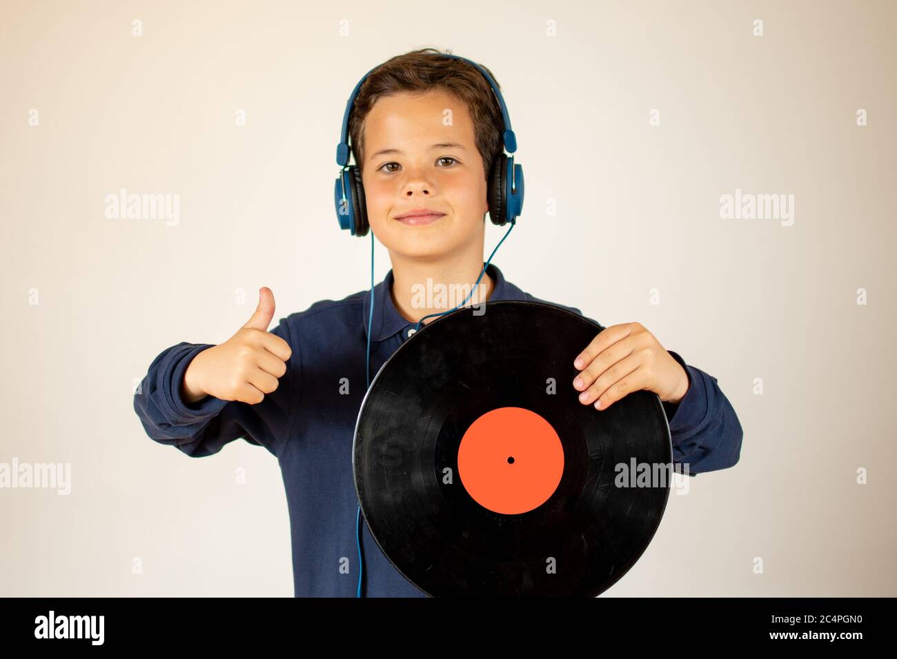 Young boy listening to music with disc in his hand Stock Photo - Alamy
