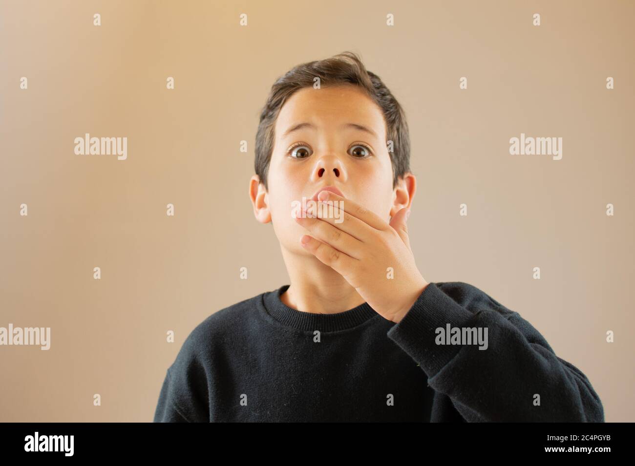 Young boy in shock gesture Stock Photo - Alamy
