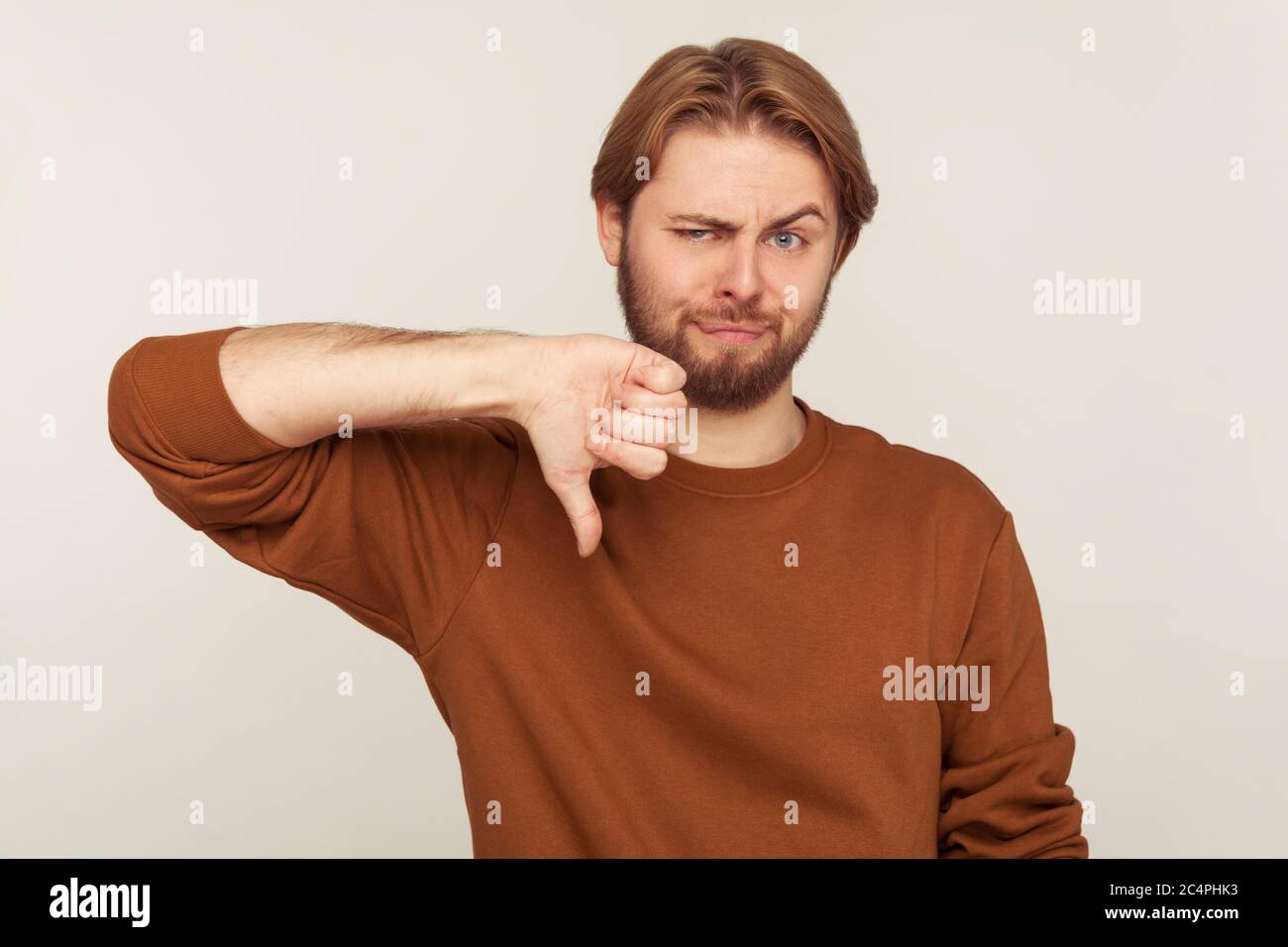 Dislike gesture. Portrait of displeased bearded man in sweatshirt ...