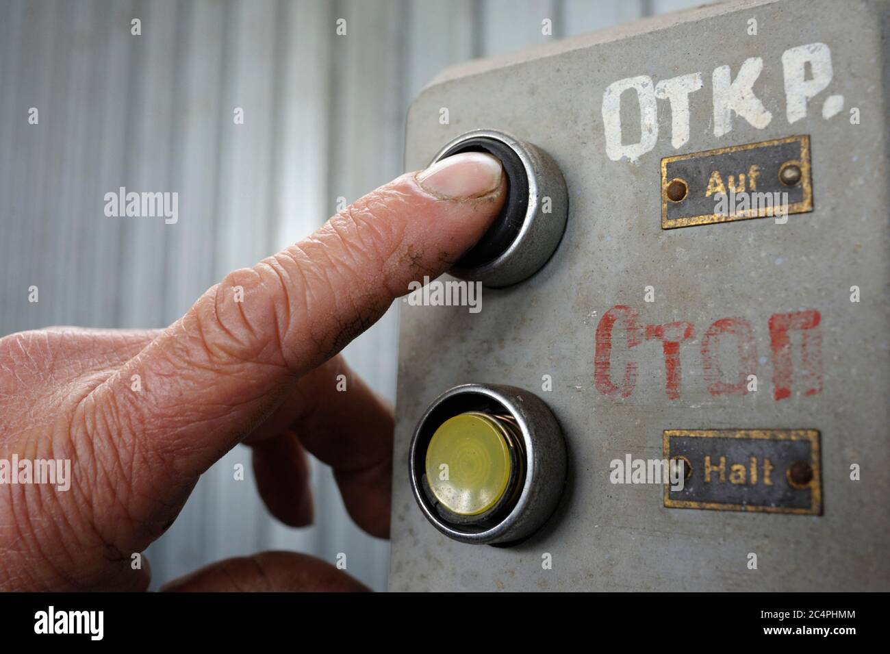 Finger of worker pushing button Open on a control panel Stock Photo - Alamy