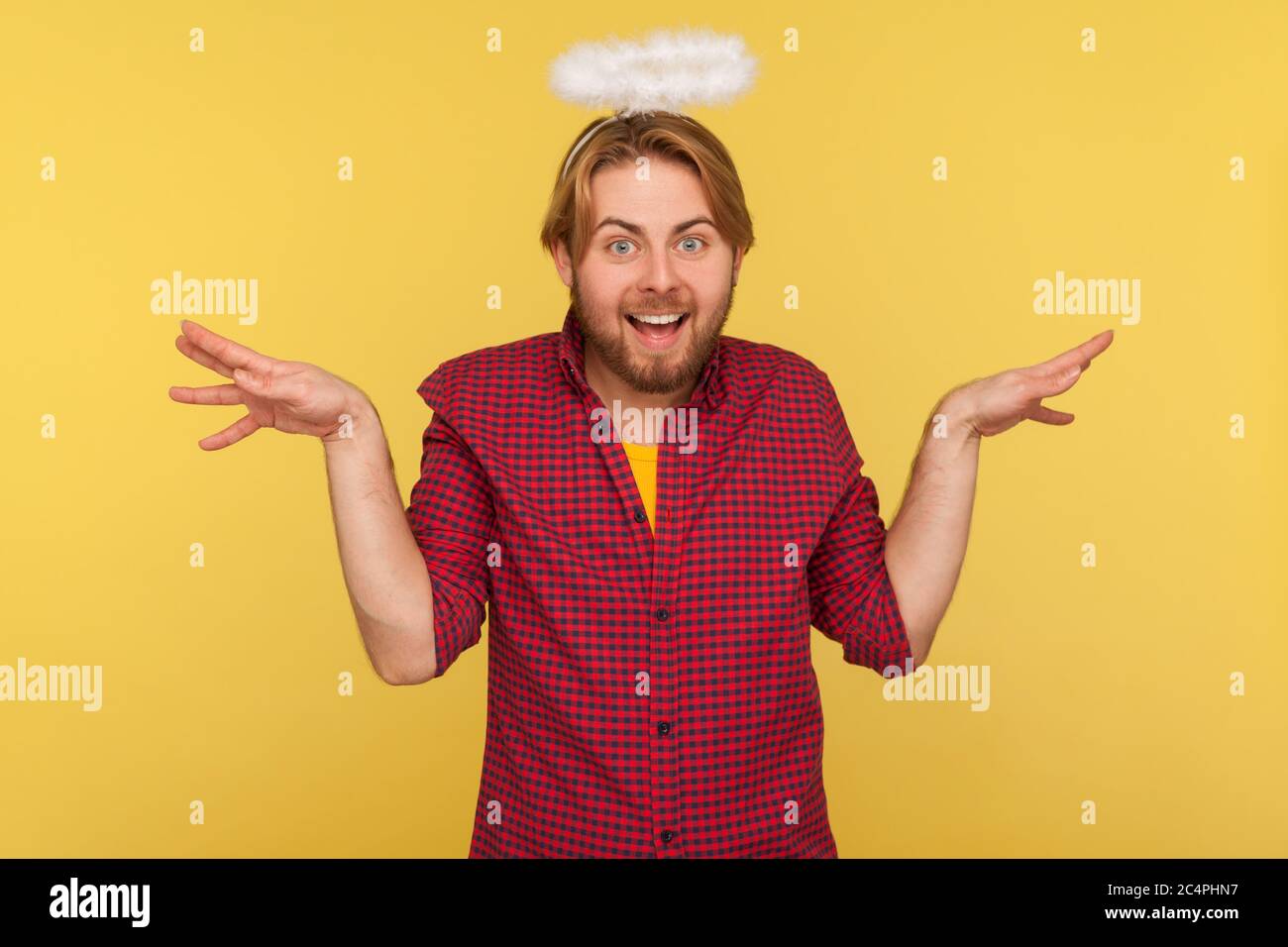 Funny cheerful bearded guy with saint nimbus over head raising hands as ...