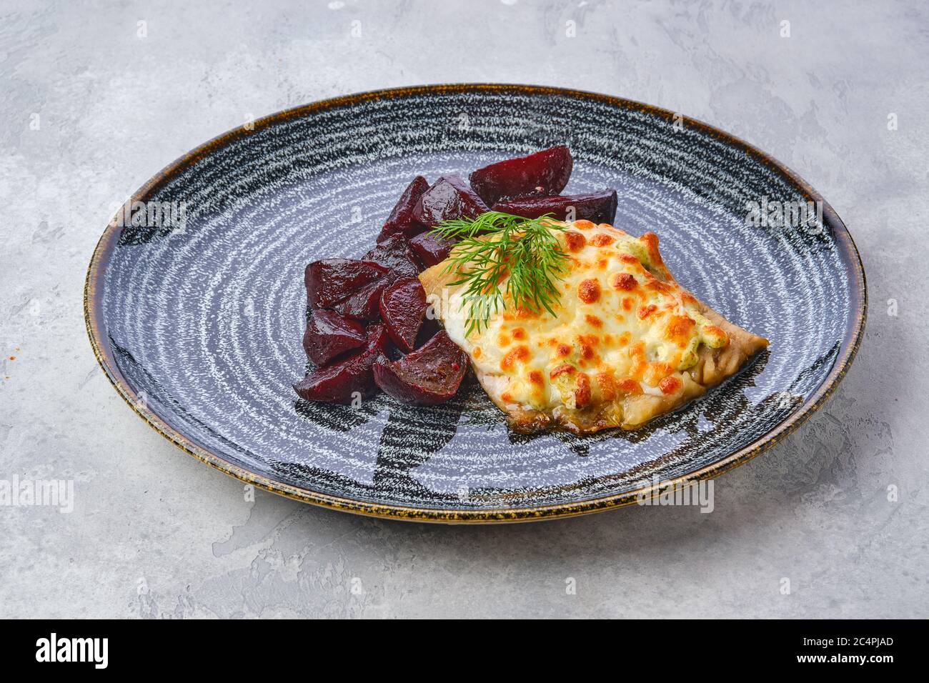 Fried cod fillet with melted cheese topping and roasted beetroot slices ...