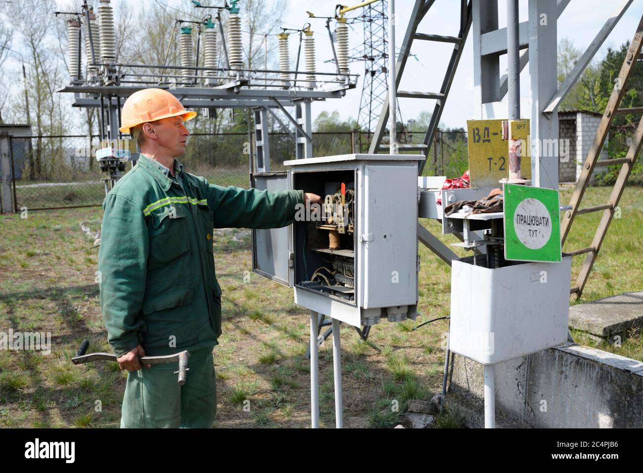 At the power substation. Worker checking connections on the electric ...