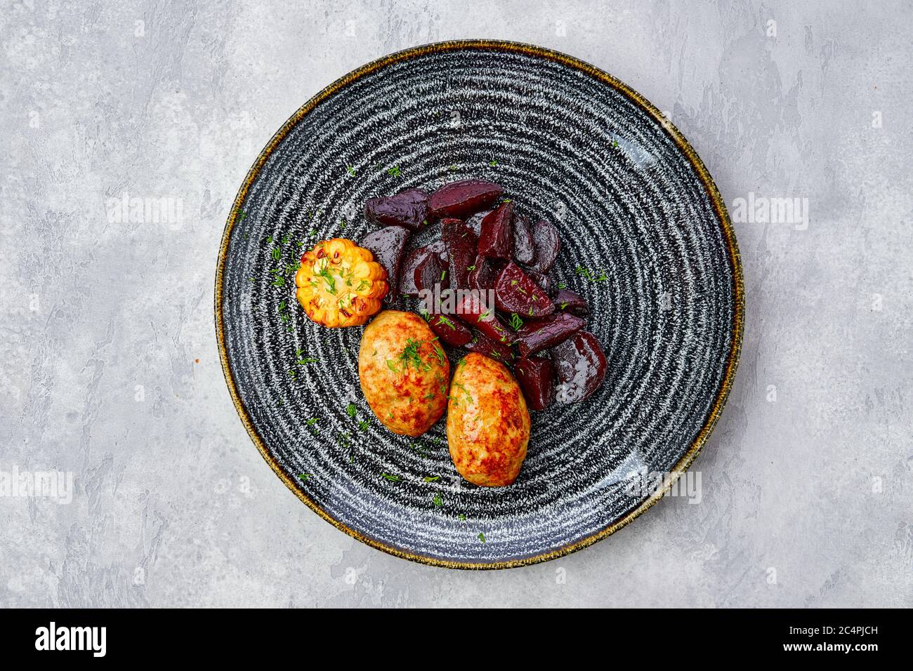 Top view of plate with fried pork cutlet with roasted beetroot slices ...