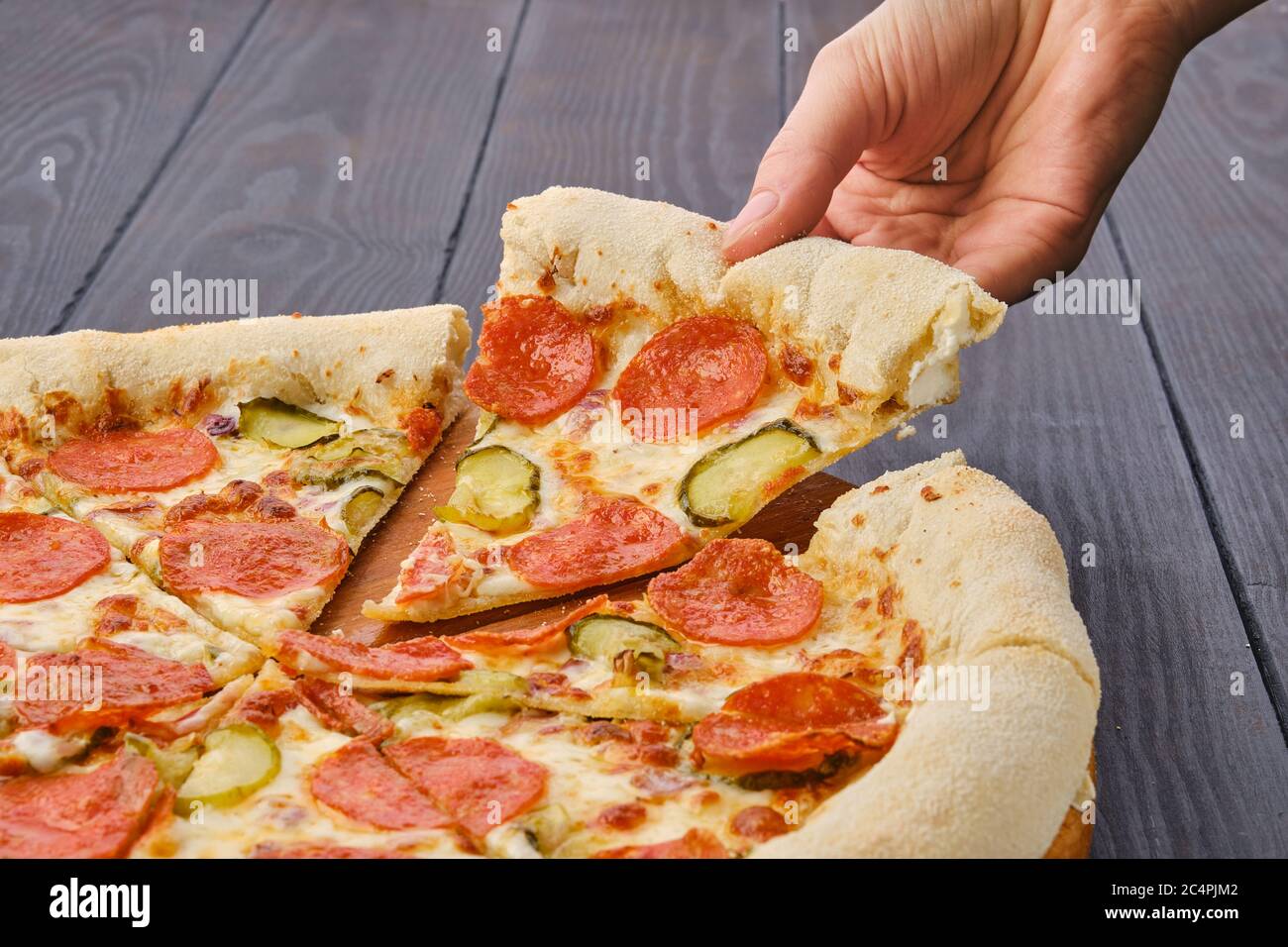 Hand taking pizza slice hi-res stock photography and images - Alamy