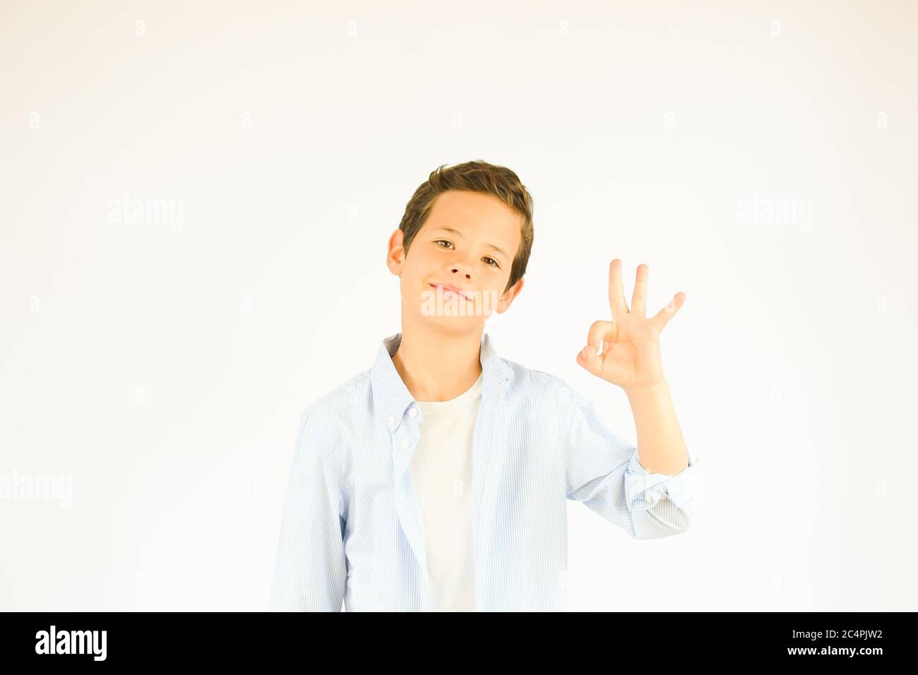 Happy boy making hand gesture Stock Photo - Alamy