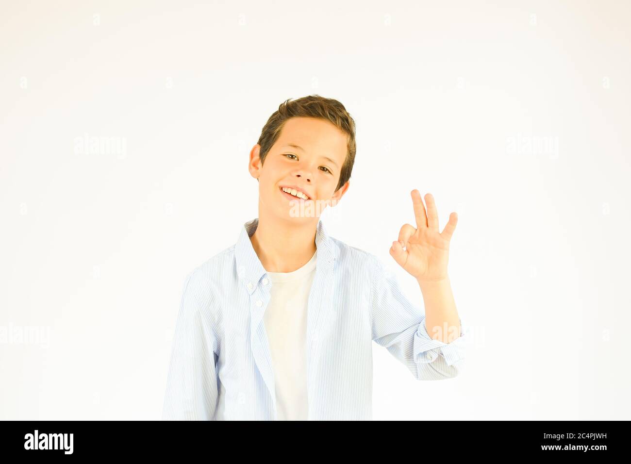 Happy boy making hand gesture Stock Photo - Alamy