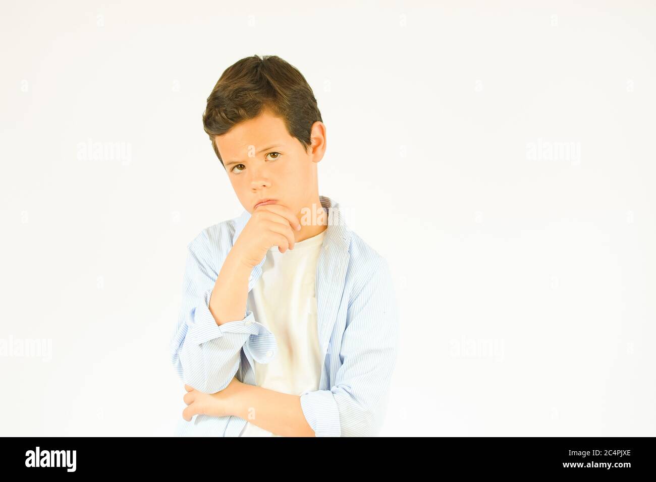 Little boy making thoughtful gesture Stock Photo - Alamy
