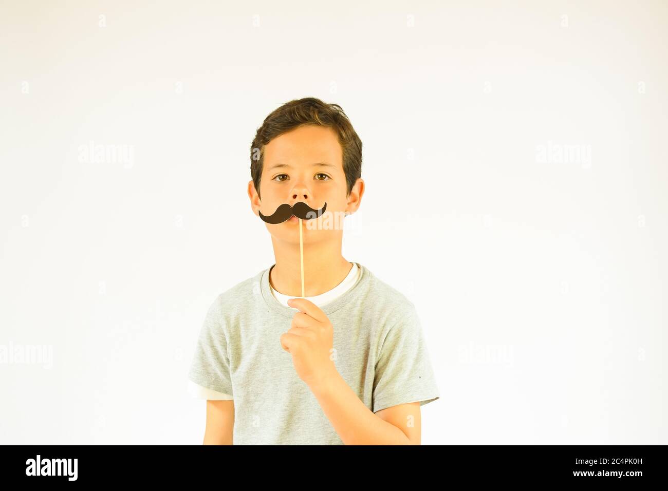 Young happy boy making mustache gesture Stock Photo - Alamy