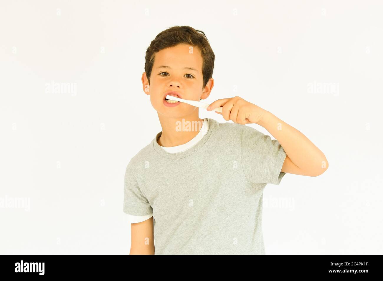 Young beautiful boy is brushing teeth Stock Photo - Alamy