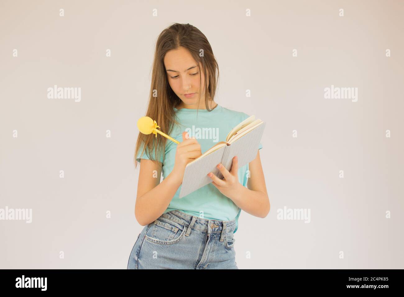 Beautiful girl taking notes with pen Stock Photo - Alamy
