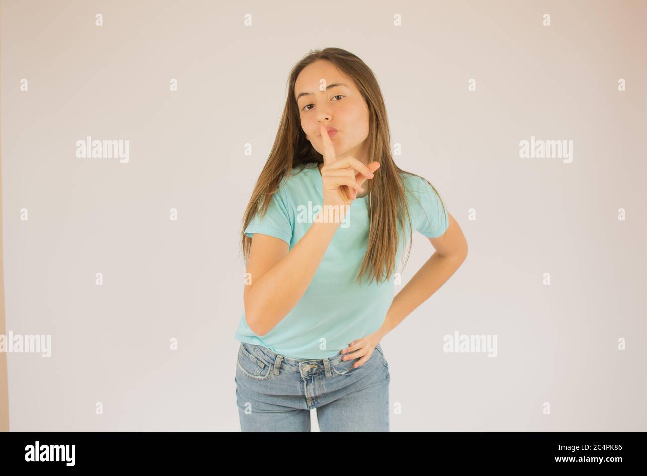 Beautiful girl making a shh gesture the camera Stock Photo - Alamy