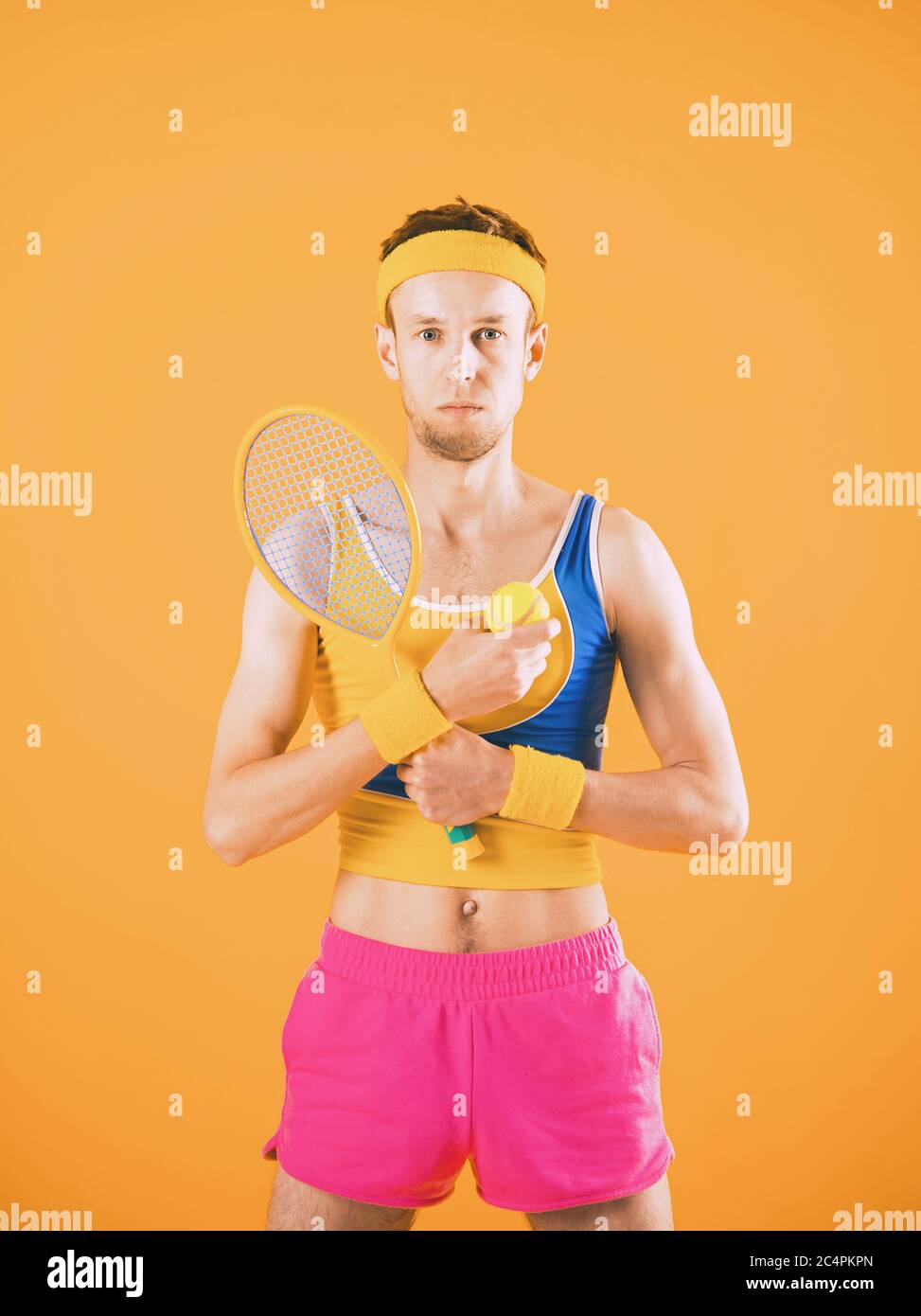 Attractive young man in casual costume holding tennis racket and ball ...