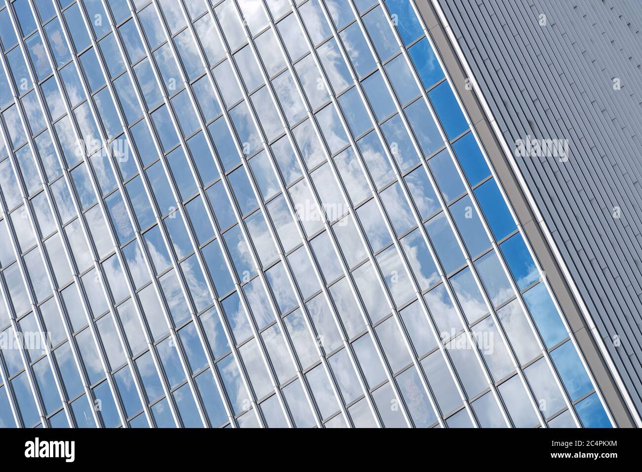 Close up detail of reflected glass facade with rectangular windows grid ...
