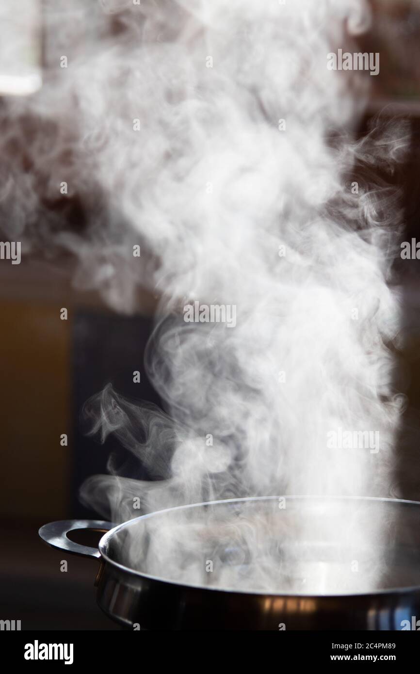 Smoke coming out of a pot with boiling water Stock Photo - Alamy