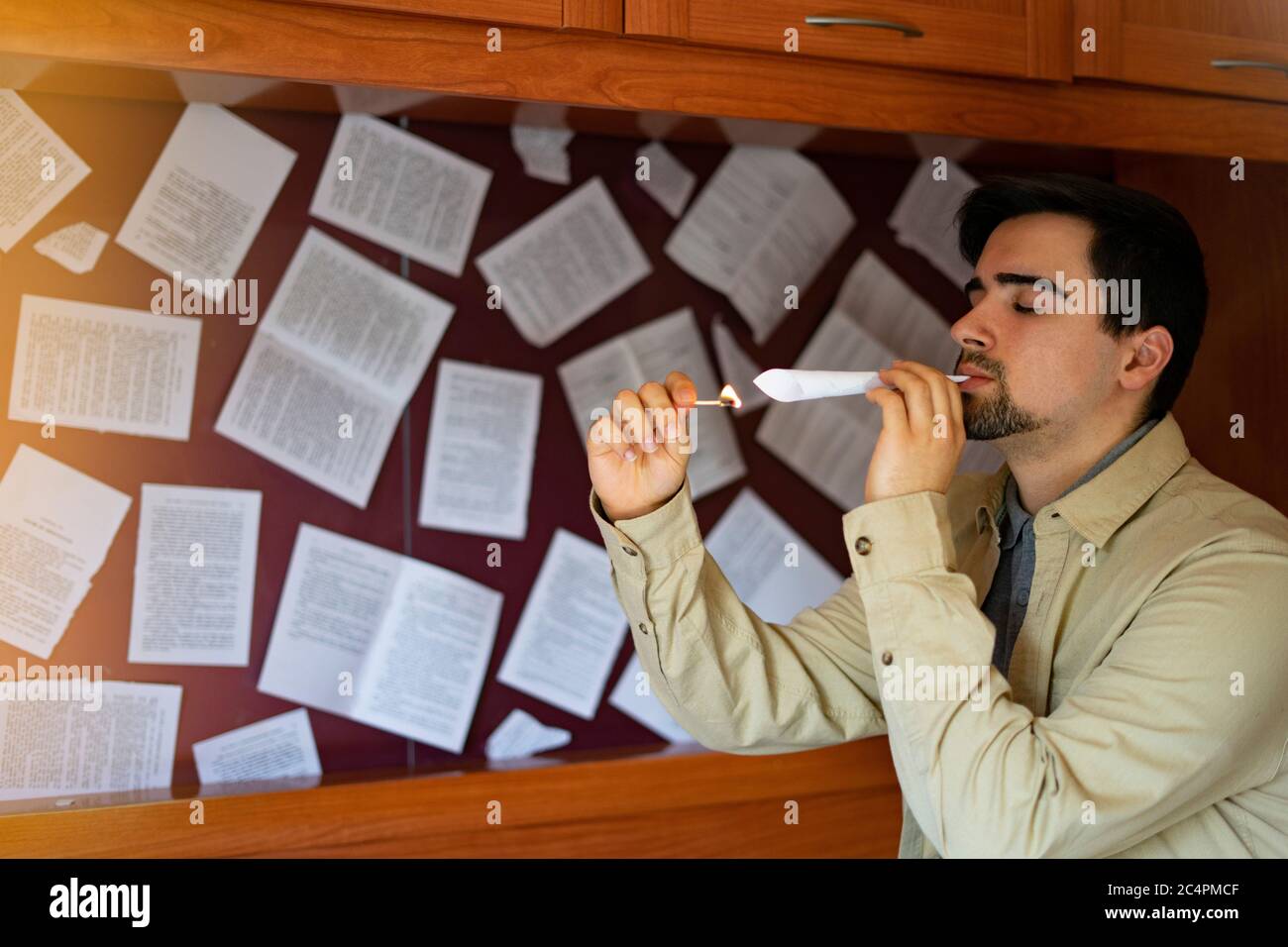 Man smoking the sheet of a book. Writer concept. Creative anxiety Stock ...