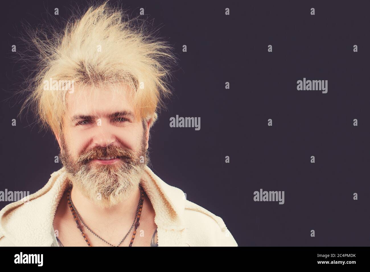 Goofy young man, with full beard and moustache and wild hair, pull a ...