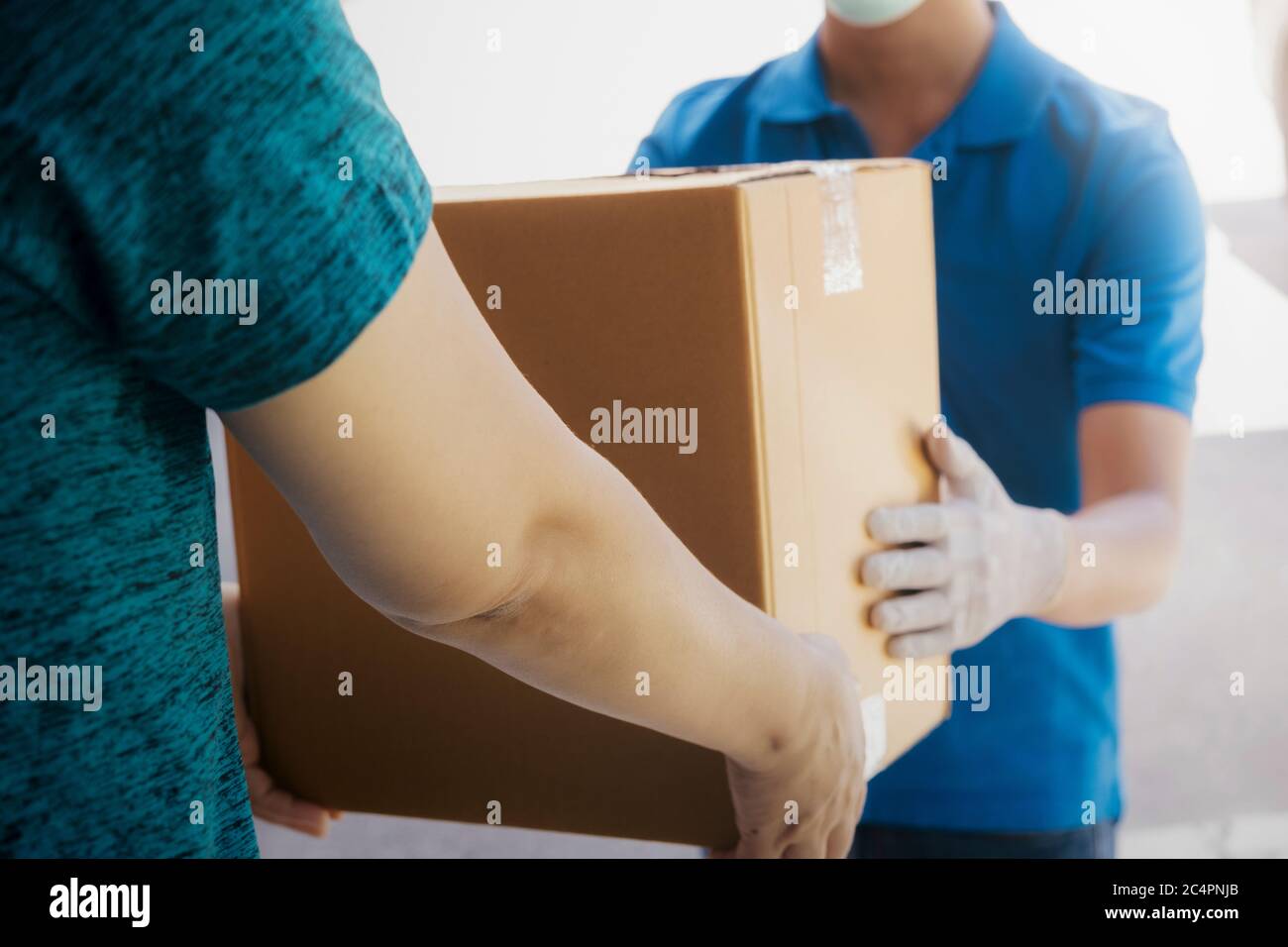 Young woman receiving parcel from delivery man. Delivery Service Stock ...