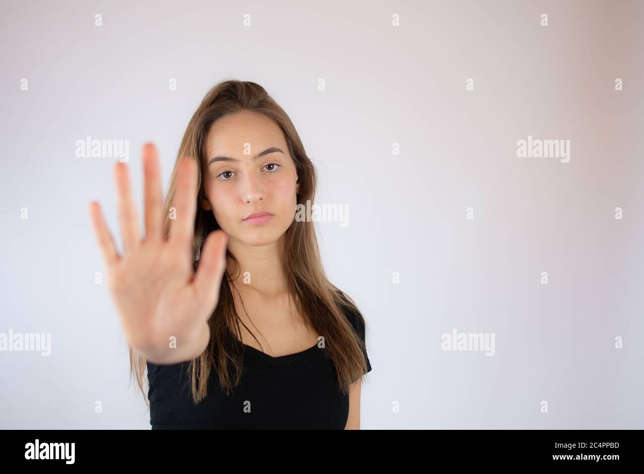 Pretty young girl making stop hand gesture Stock Photo - Alamy