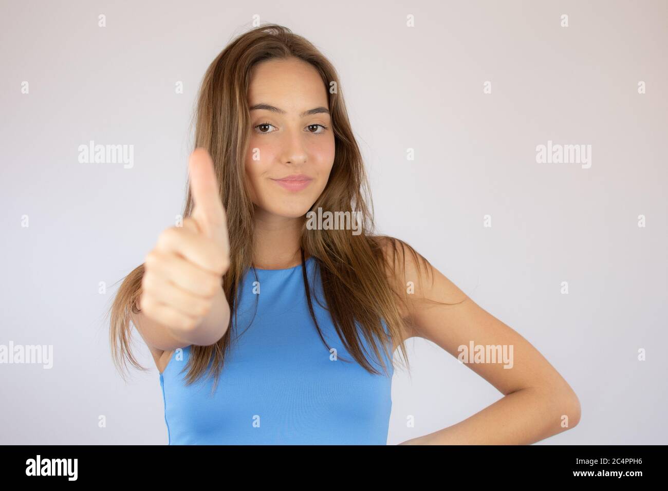 Beautiful young girl making finger up gesture Stock Photo - Alamy