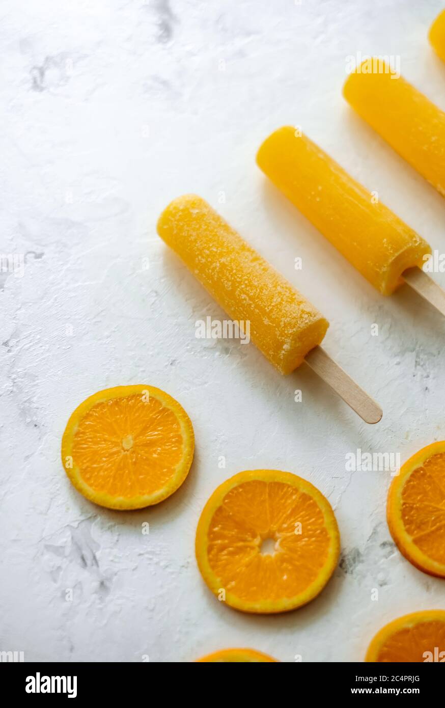 Orange fruit ice sorbet with slices of fresh orange. Stick ice cream ...