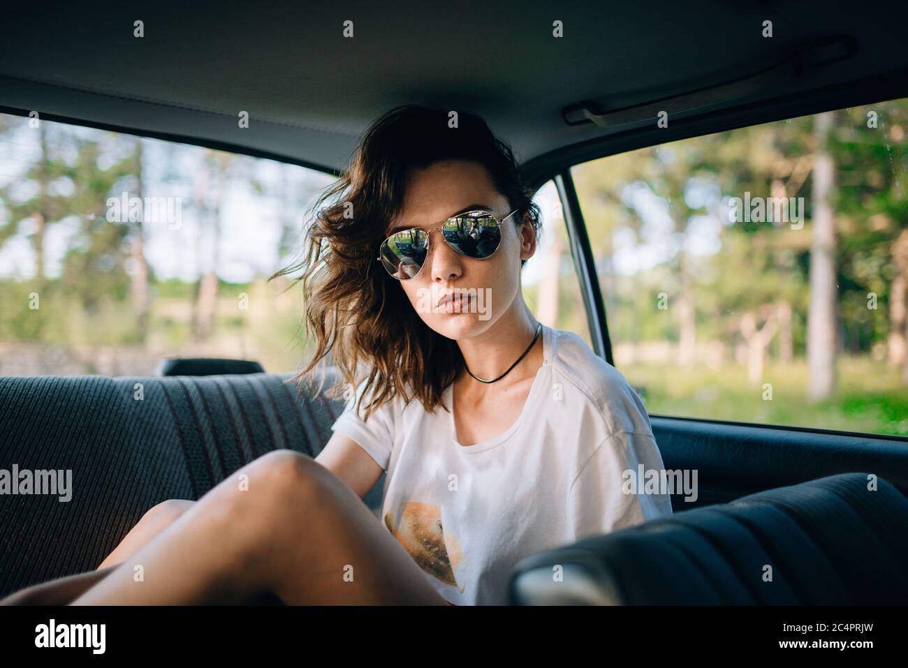 Portrait of a girl in the back seat of a car Stock Photo - Alamy