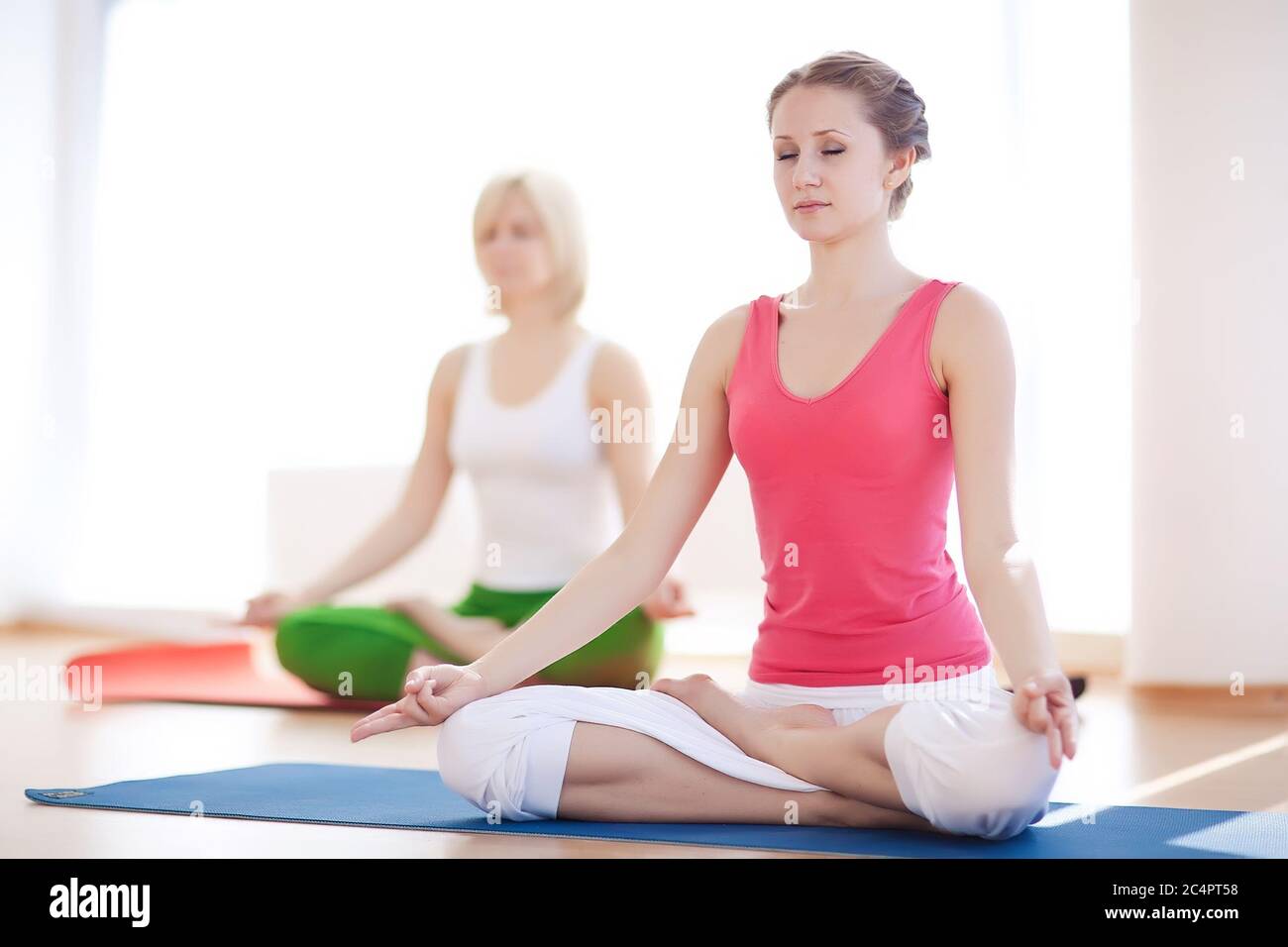 A woman practices yoga in the studio Stock Photo - Alamy
