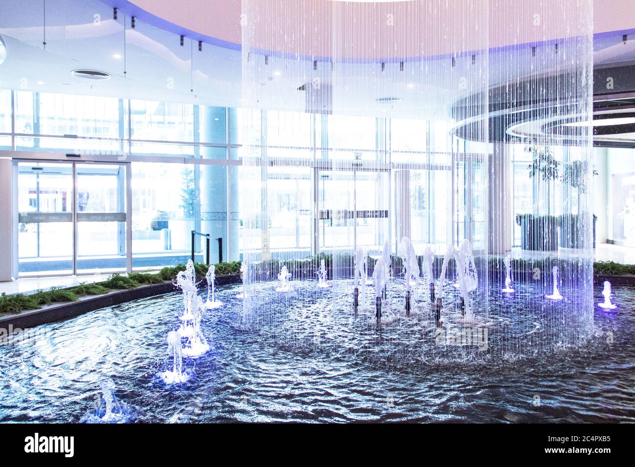 Vertical water jet fountains in a shopping mall Stock Photo - Alamy