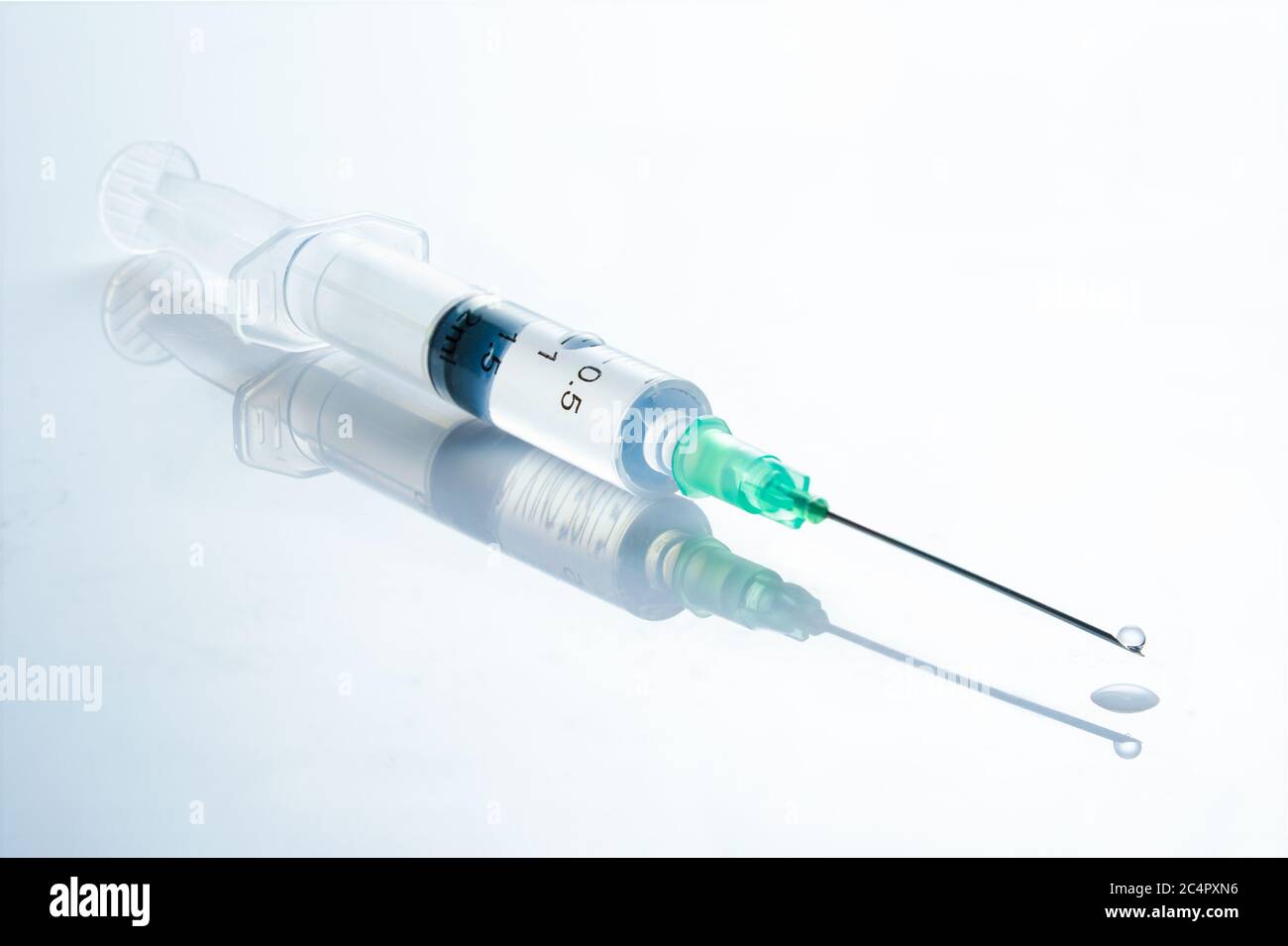 Syringe with medicinal solution, on light blue background with ...