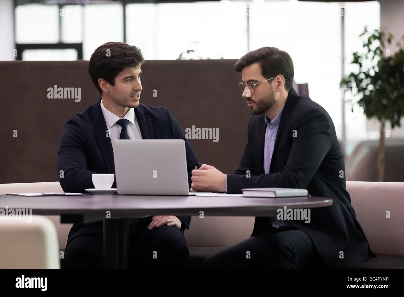 Two serious business men working at new idea together Stock Photo - Alamy