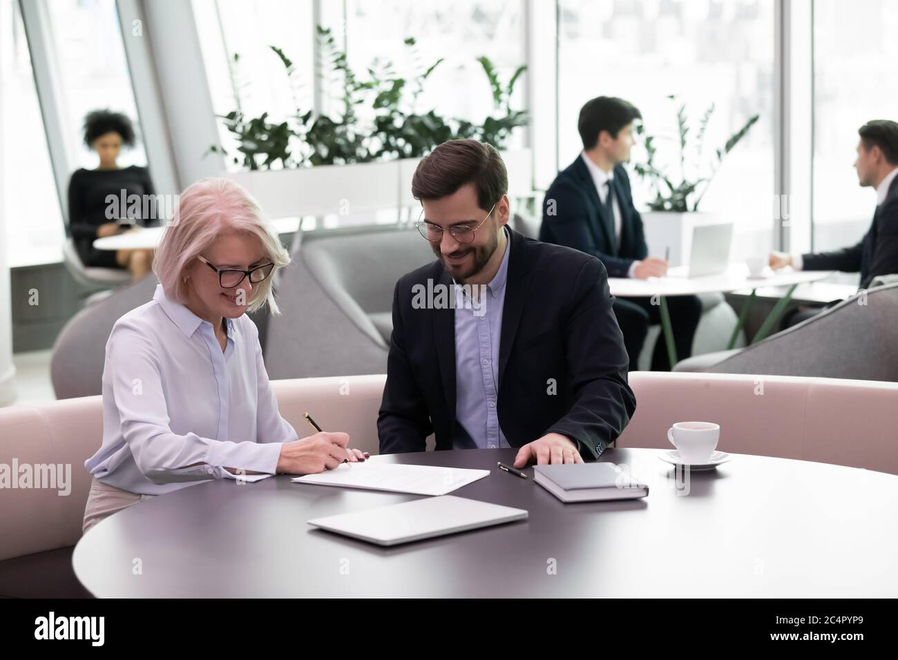 Senior happy business woman sign contract making deal with partner ...