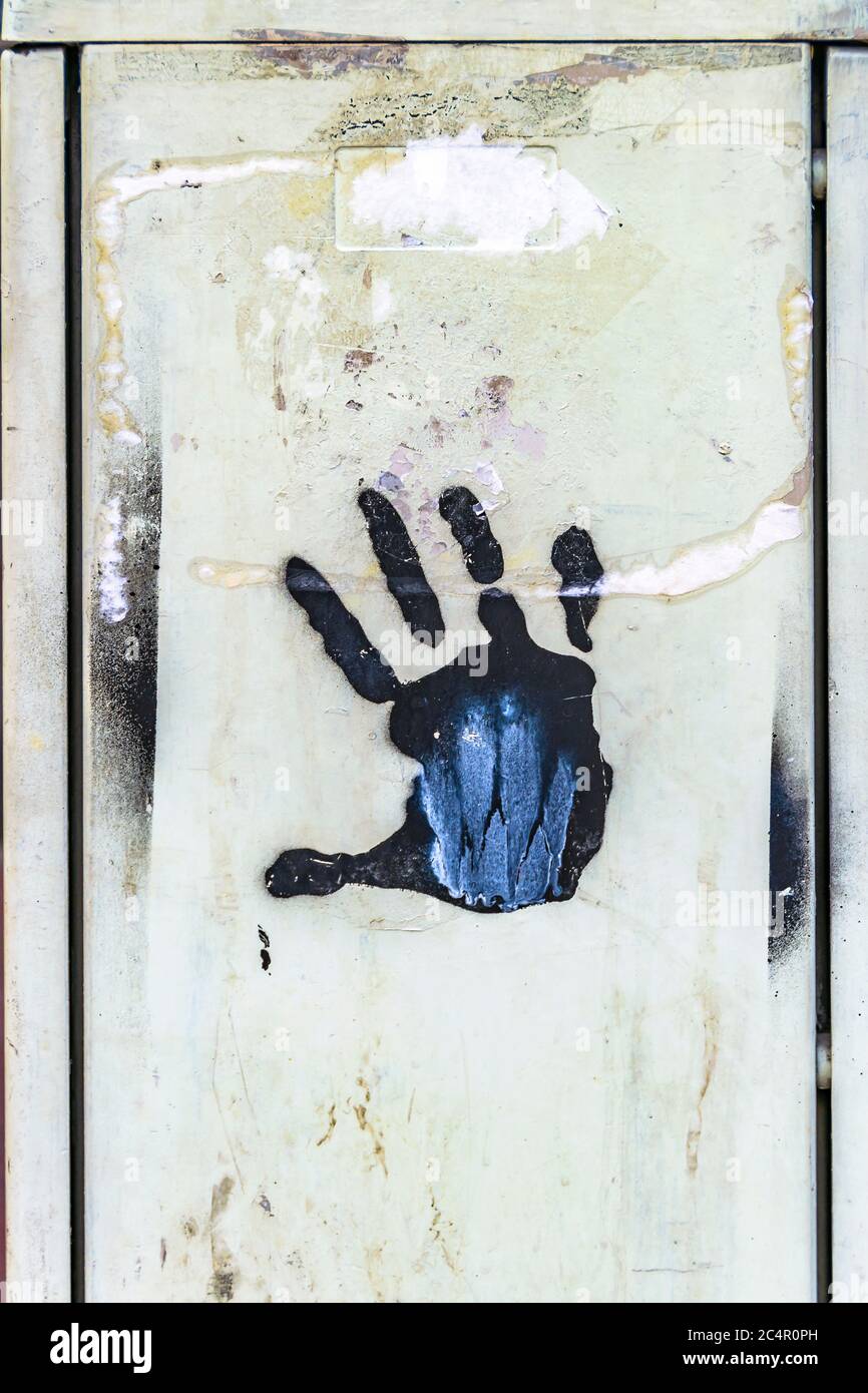 Black hand shape urban art painted on wall Stock Photo - Alamy