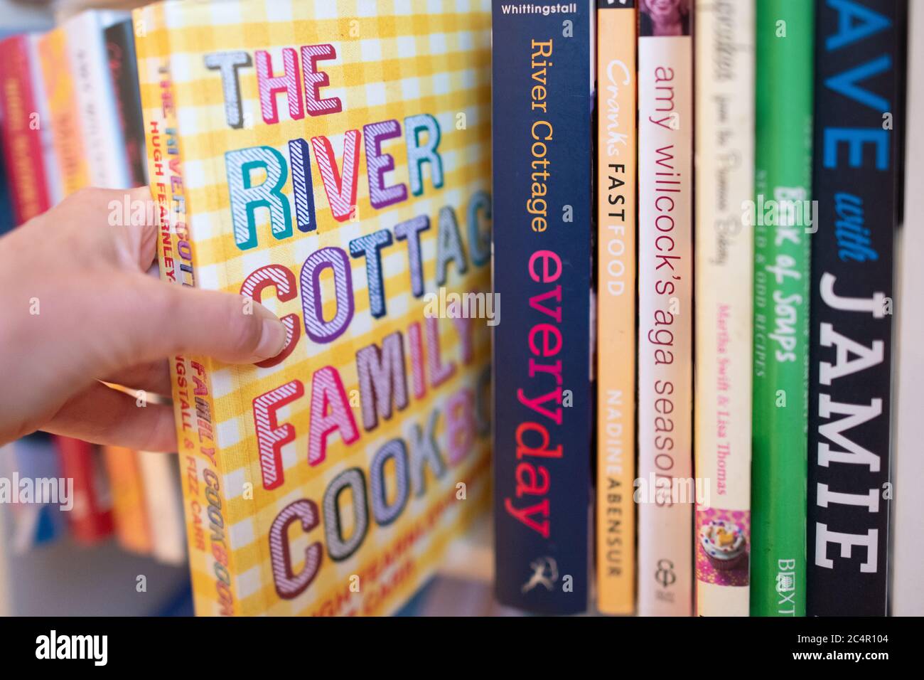 Hand taking family cookery book from shelf hi-res stock photography and ...