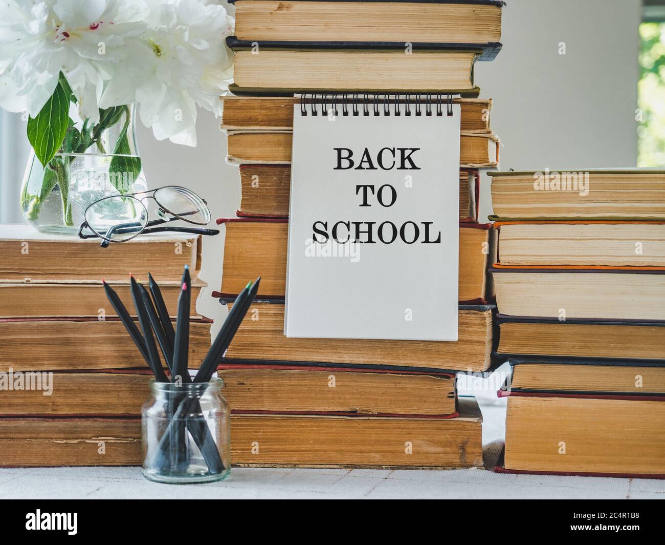Stack of vintage books and beautiful flowers Stock Photo - Alamy
