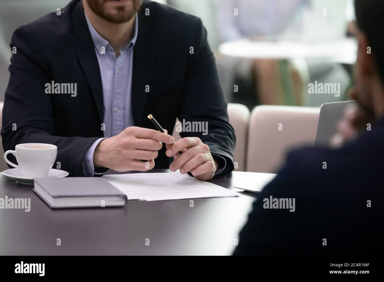 Close up of business advisor making notes while meeting client Stock ...
