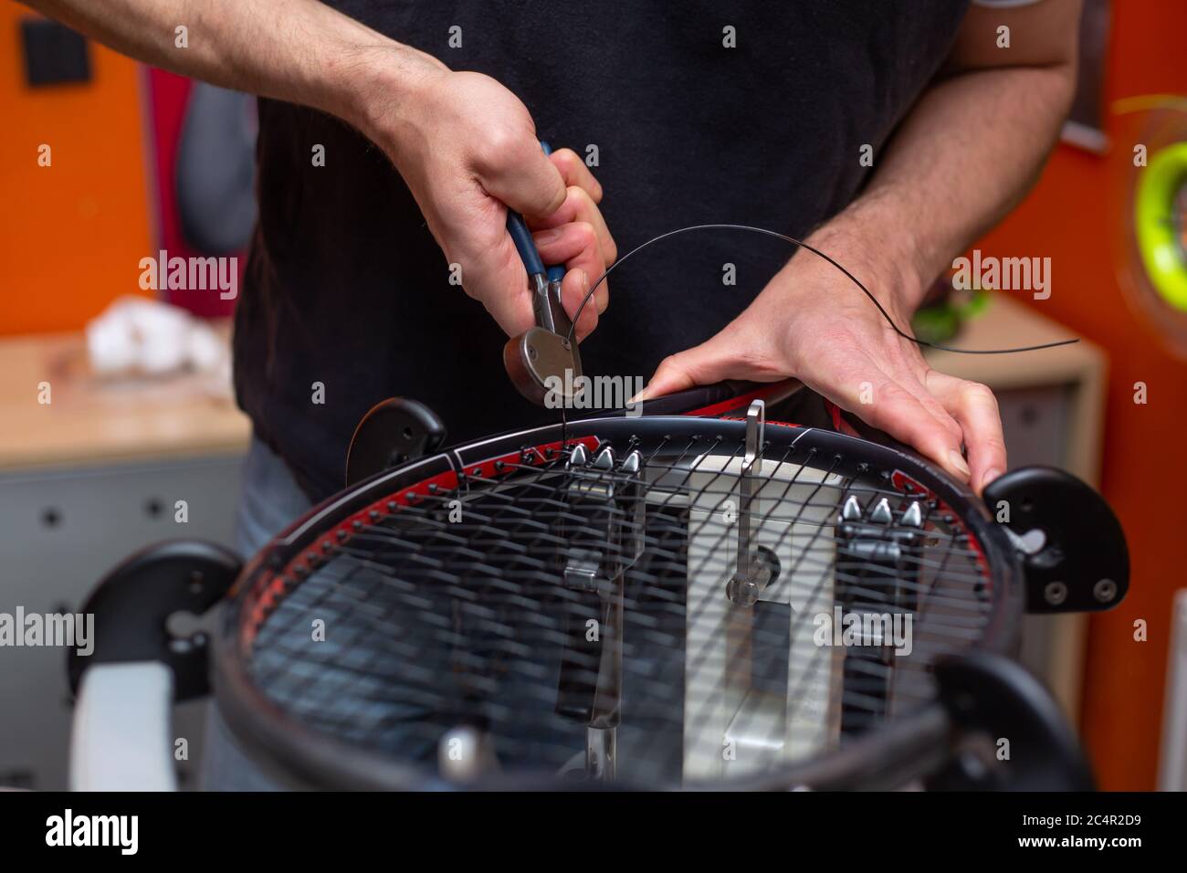 Process of stringing a tennis racket in a tennis shop, sport and ...